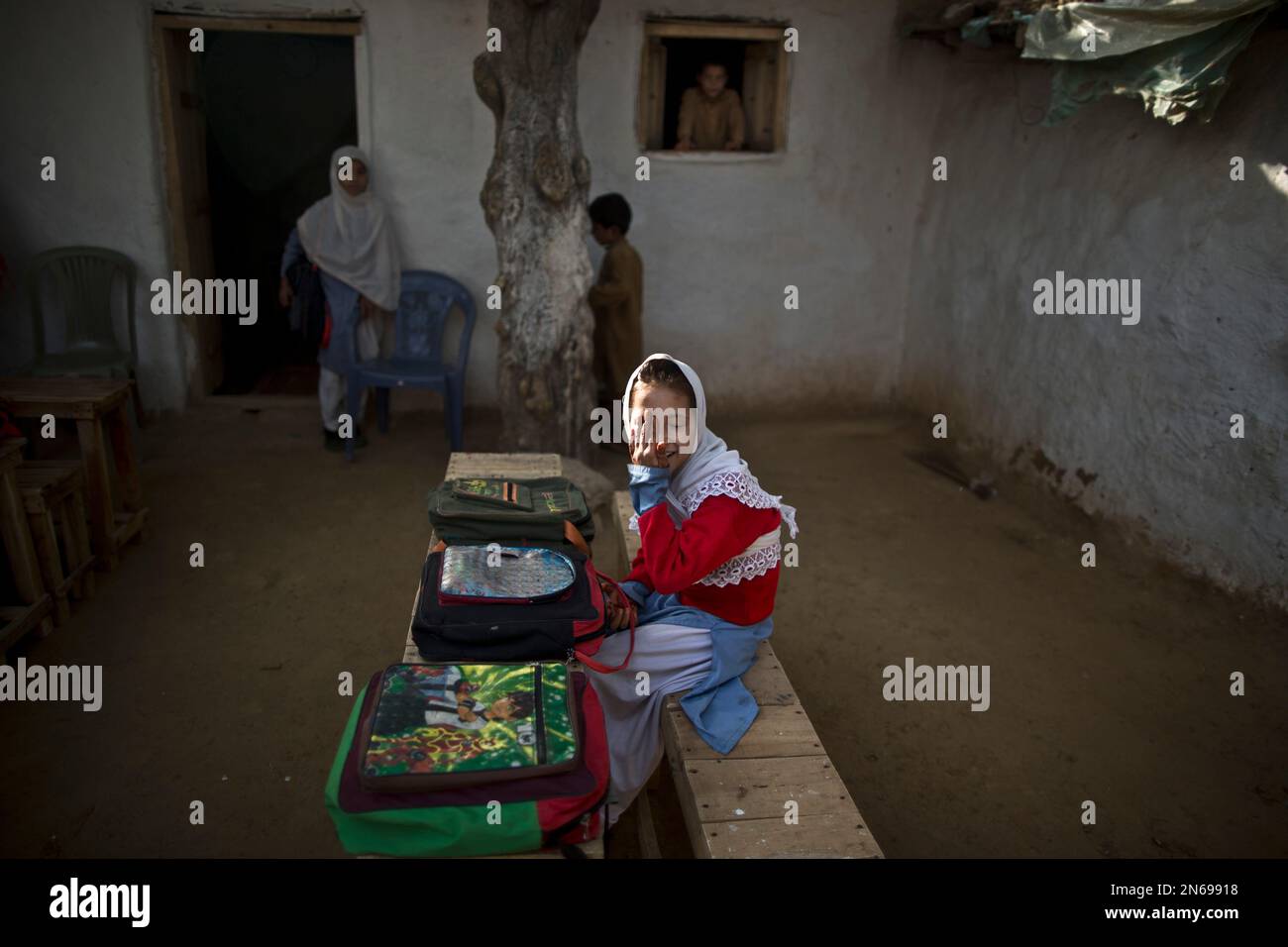 A Pakistani schoolgirl, who was displaced with her family from Pakistan ...