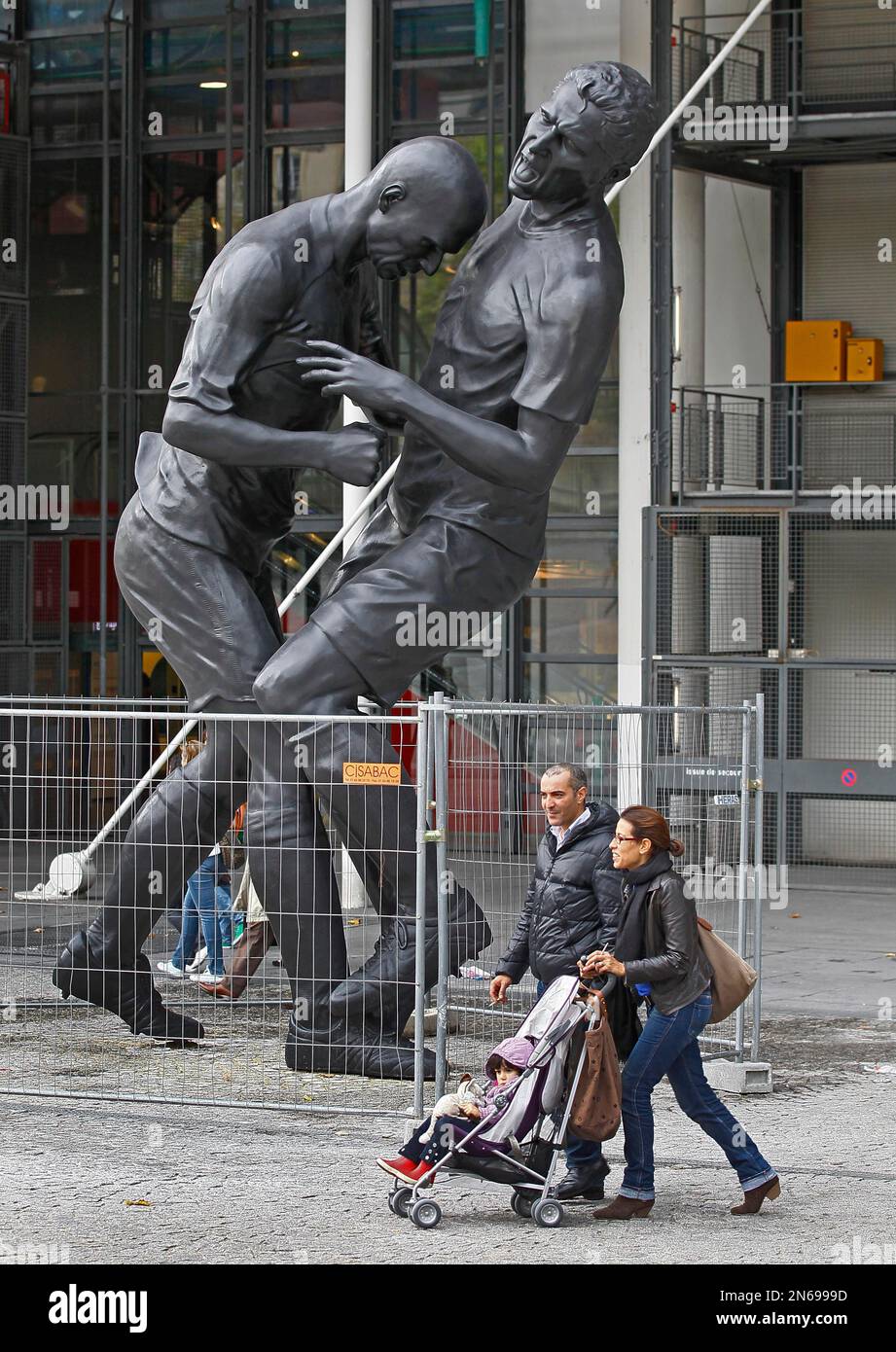 FILE - In this Wednesday Sept. 26, 2012 file photo, a couple walk past ...