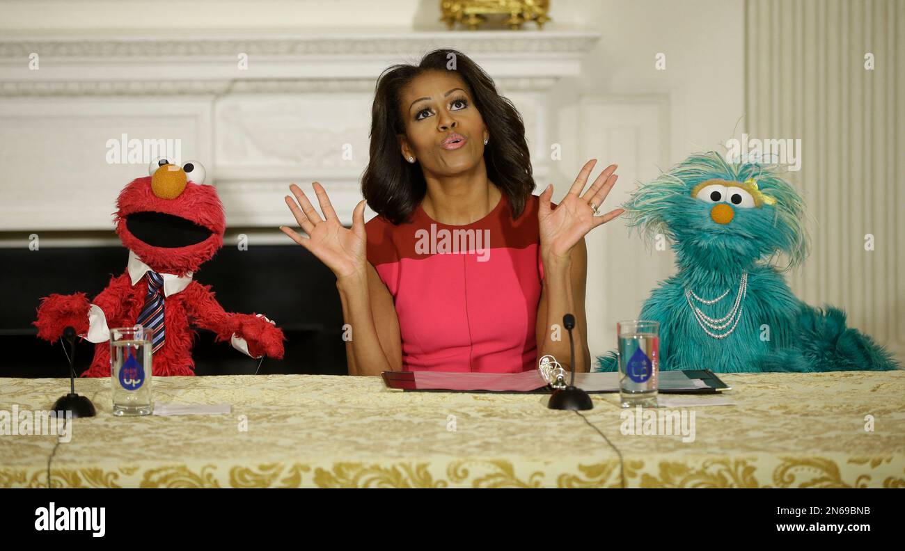 First lady Michelle Obama, center, with PBS Sesame Street's characters ...