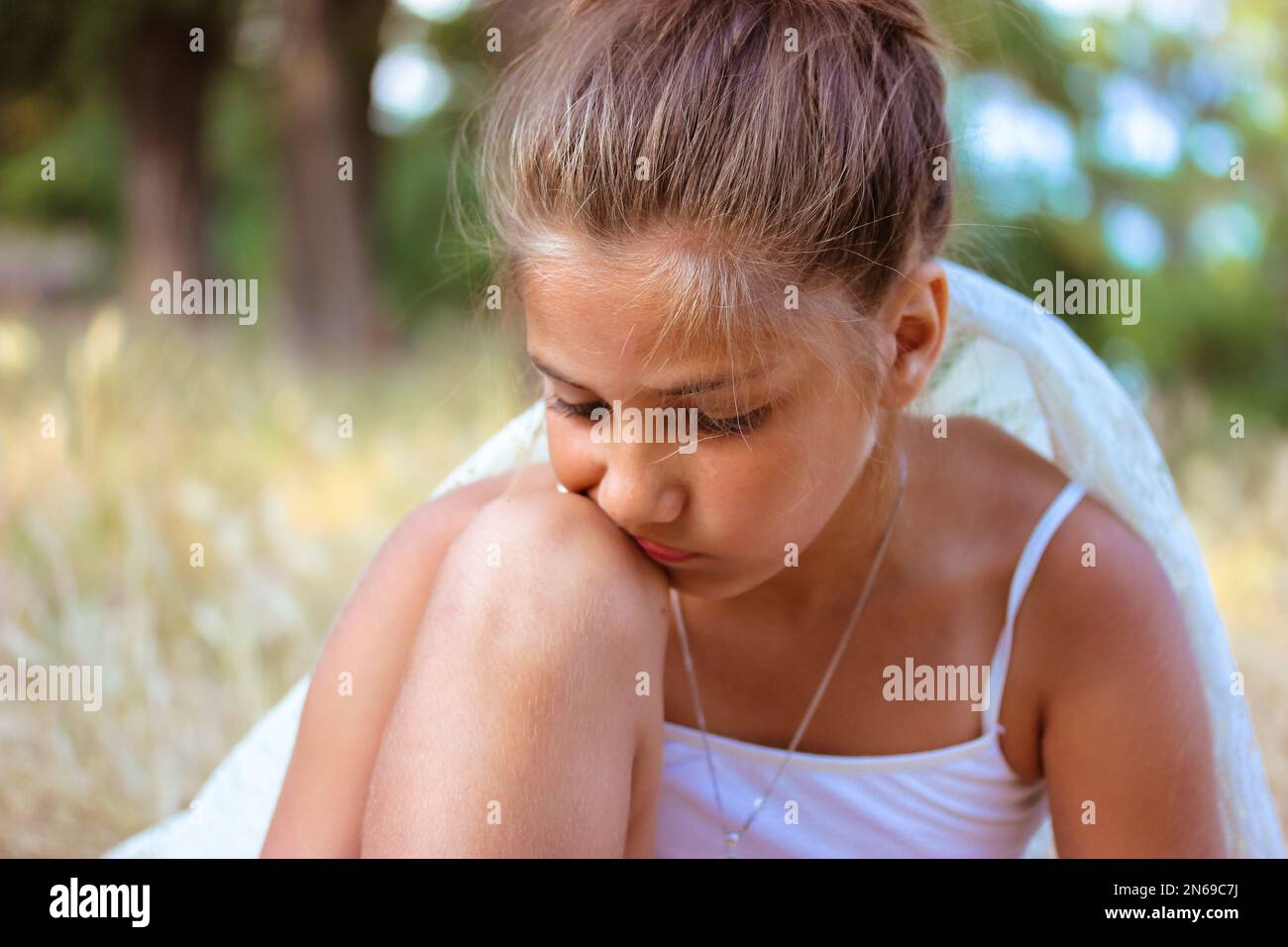 Sad little school-aged teenage caucasian girl on summer camp, vacation ...