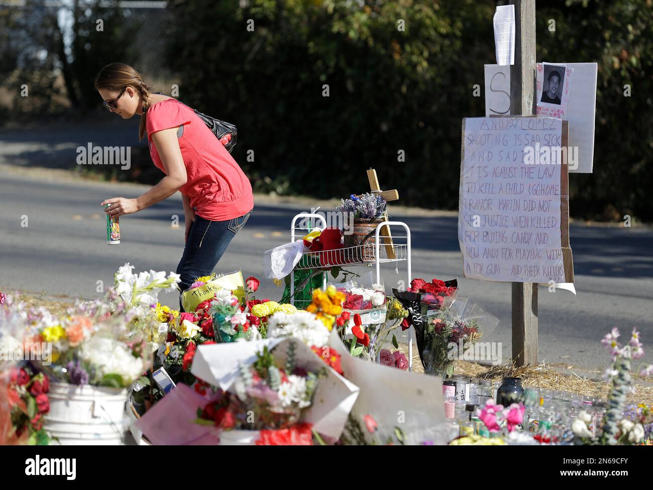 Robin Betts stops to place a candle at a memorial Wednesday, Oct. 30 ...