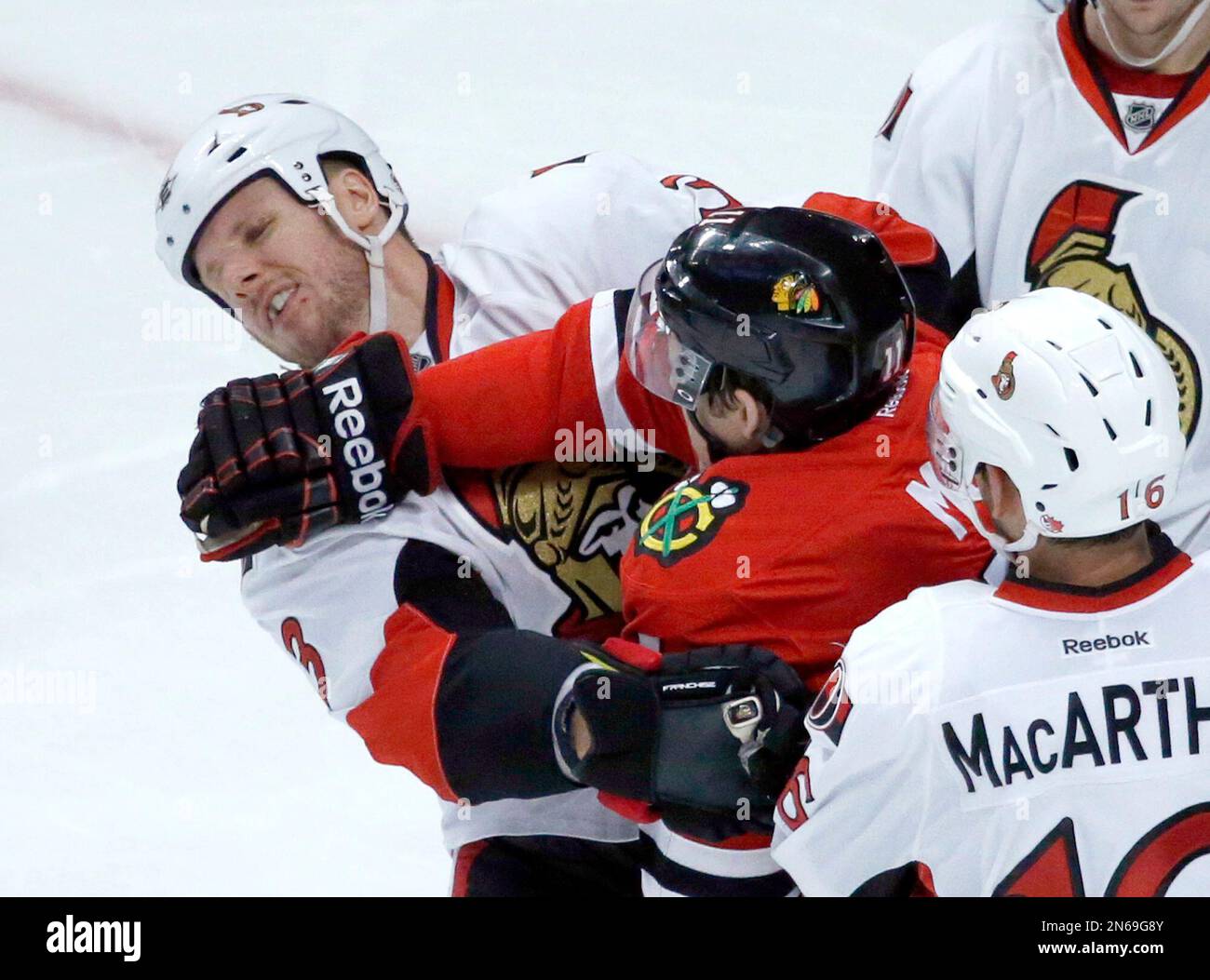 Chicago Blackhawks left wing Jeremy Morin, right, pushes on the face of ...