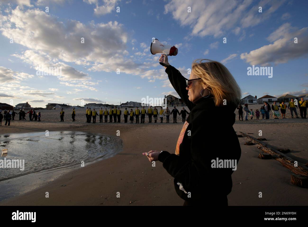 Organizer Lily Corcoran signals with a bullhorn the start of a ...