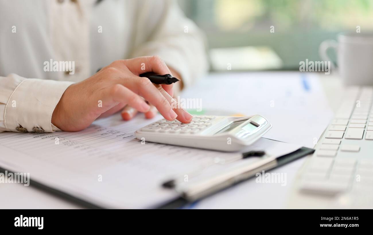 Close-up image of a businesswoman or female accountant using calculator ...