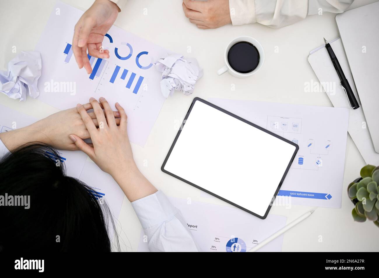 Top view, A stressed Asian female office worker gets a complaint from ...