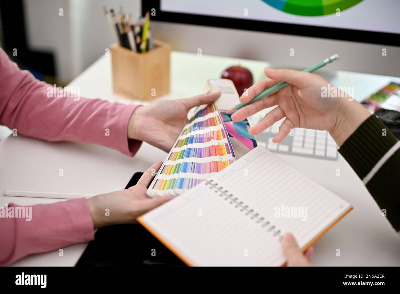 Close-up image of two graphic designers designing their new product ...