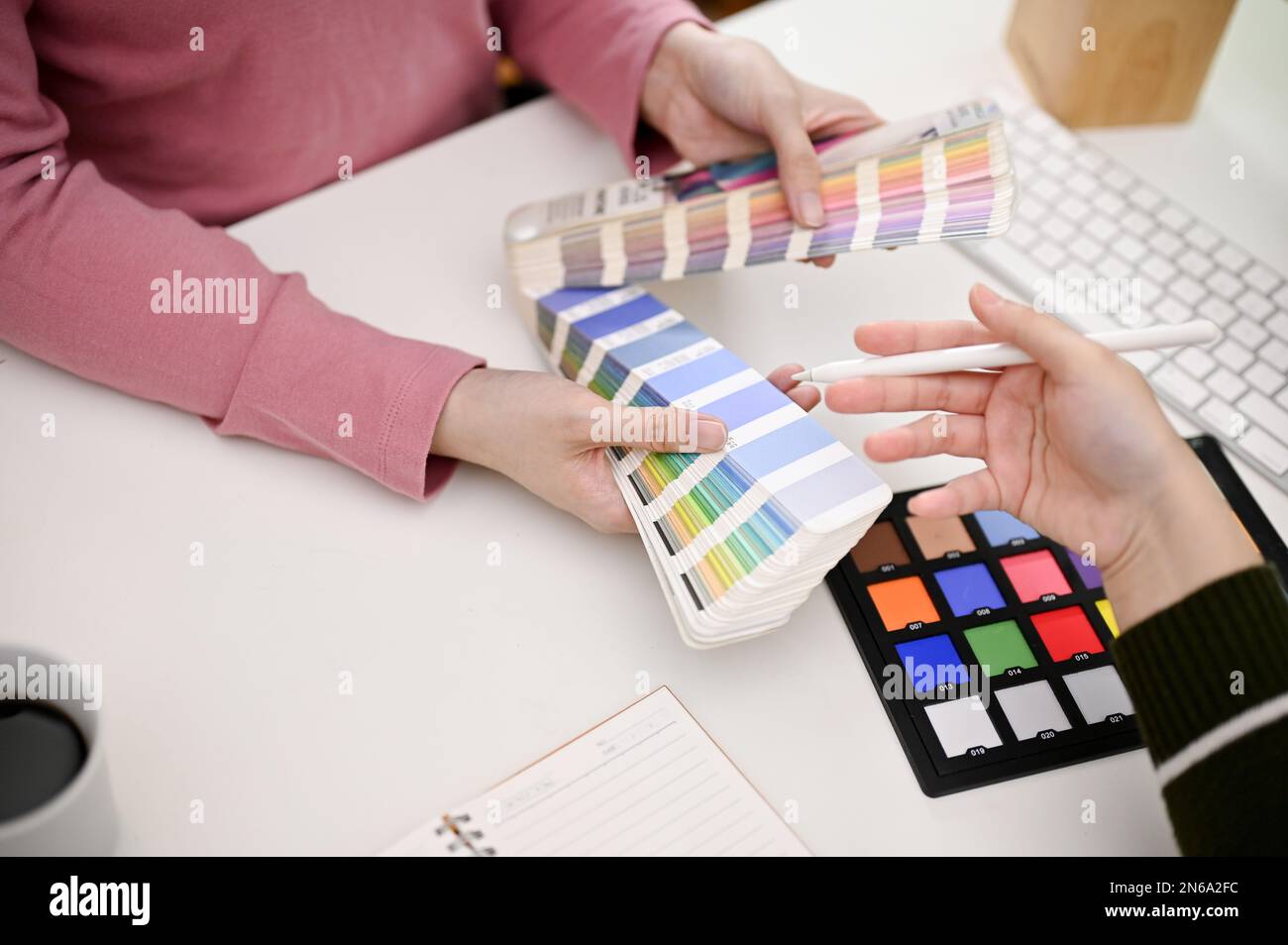 Two graphic designers or editor designing their new product together in ...