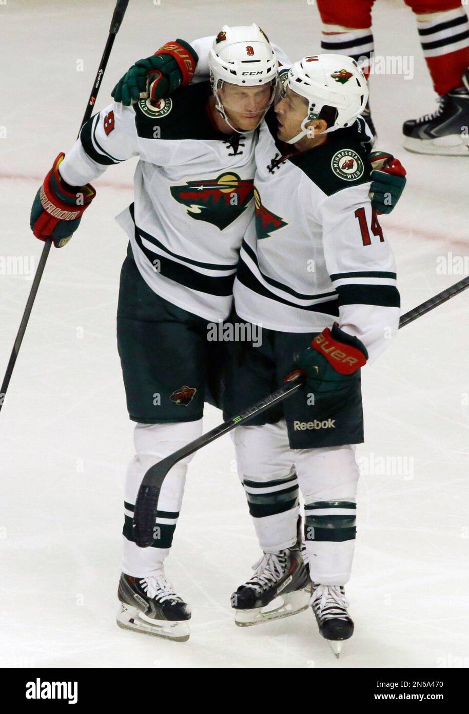 Minnesota Wild's Justin Fontaine (14), right, celebrates with Mikko ...