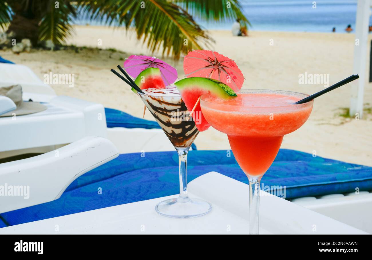 Tropical cocktails table by sun-lounger on beach at Rarotonga Cook ...