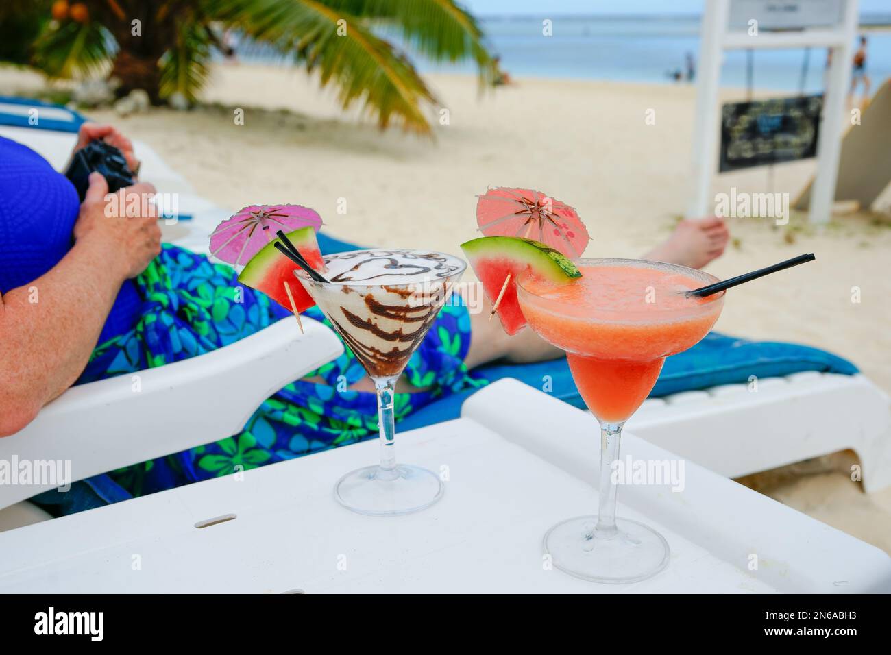 Tropical cocktails table by sun-lounger on beach at Rarotonga Cook ...