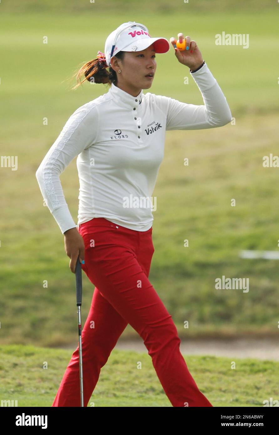 Chella Choi of South Korea waves with her ball as she finished the 18th ...
