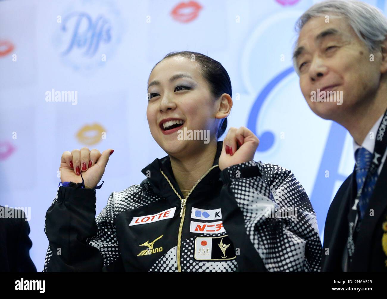 Mao Asada of Japan, sits next to her Coach Nobuo Sato after the ladies ...