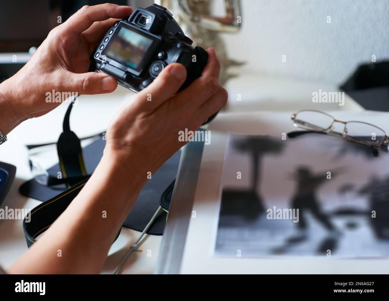 Having a look at his new camera. a mans hands holding a digital camera ...