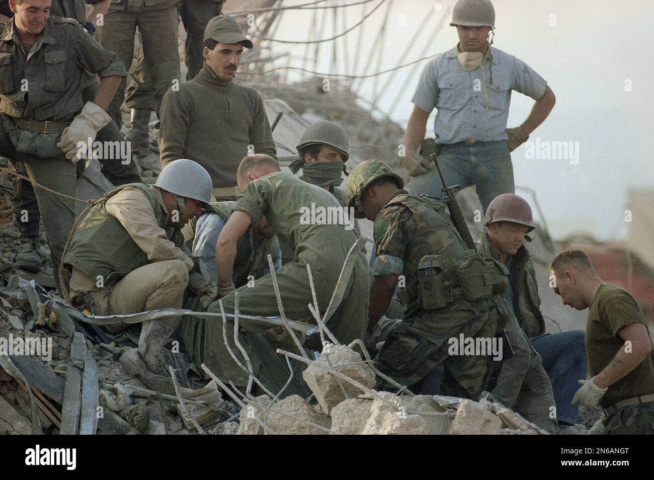 FILE -This Sunday, Oct. 23, 1983, file photo shows service members digging through rubble after ...