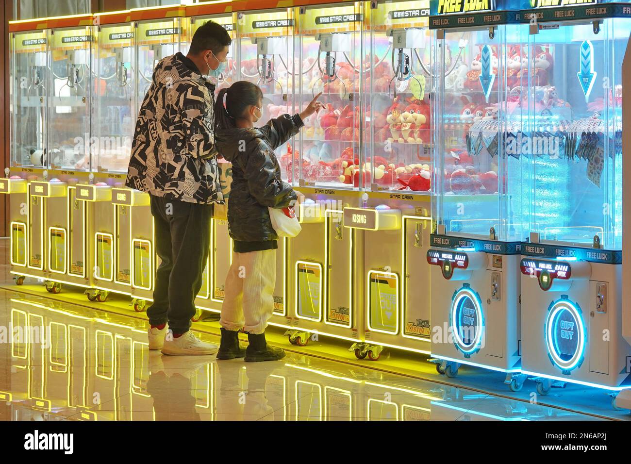 YANTAI, CHINA - FEBRUARY 10, 2023 - People play with the doll grabbing ...
