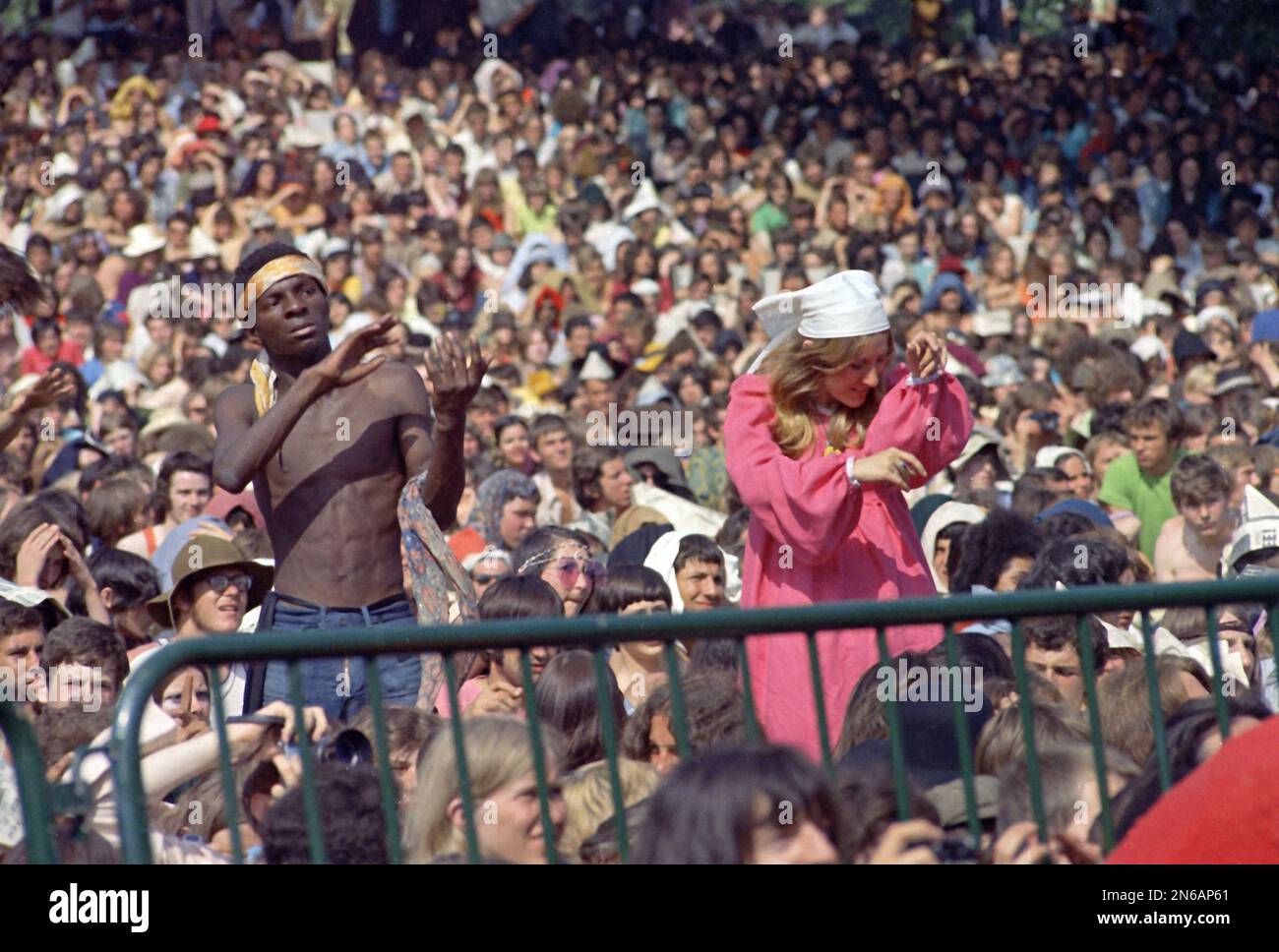 Some of the 250,000 people sit and listen, whilst some dance, at the ...