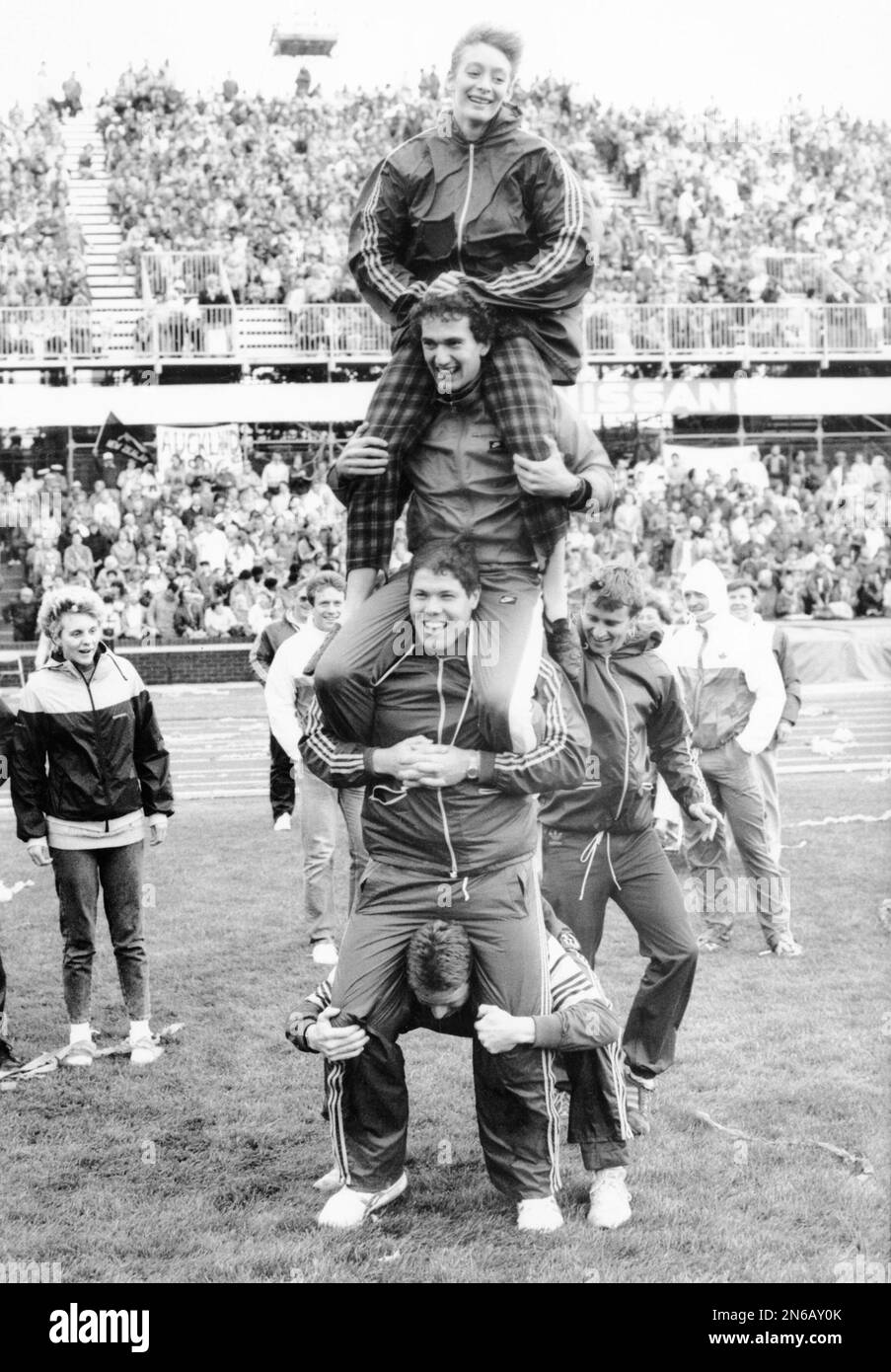 Athletes climb on each other during the Closing Ceremony of the 13th ...