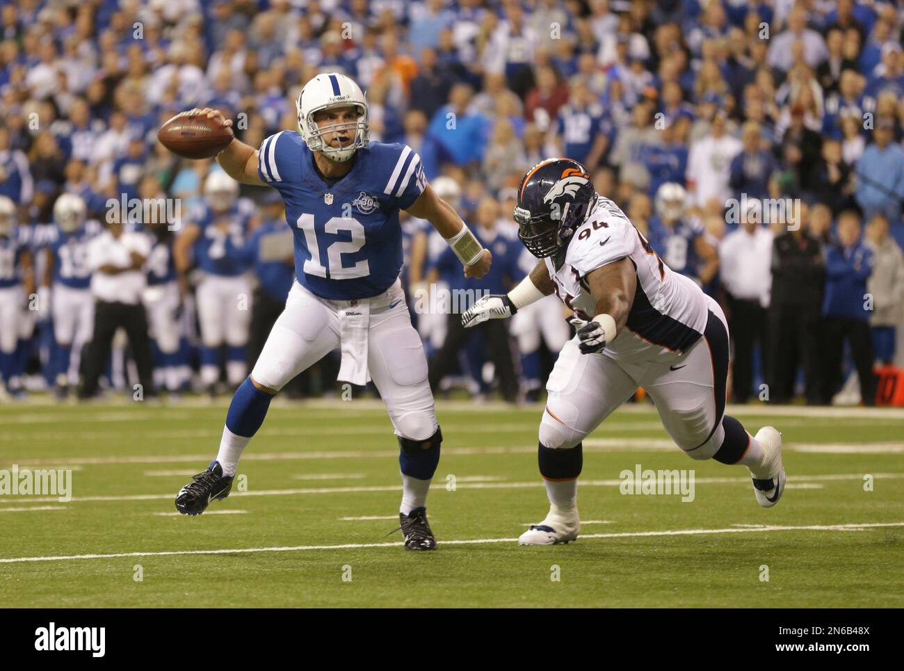 Indianapolis Colts quarterback Andrew Luck (12) is pressured by Denver ...