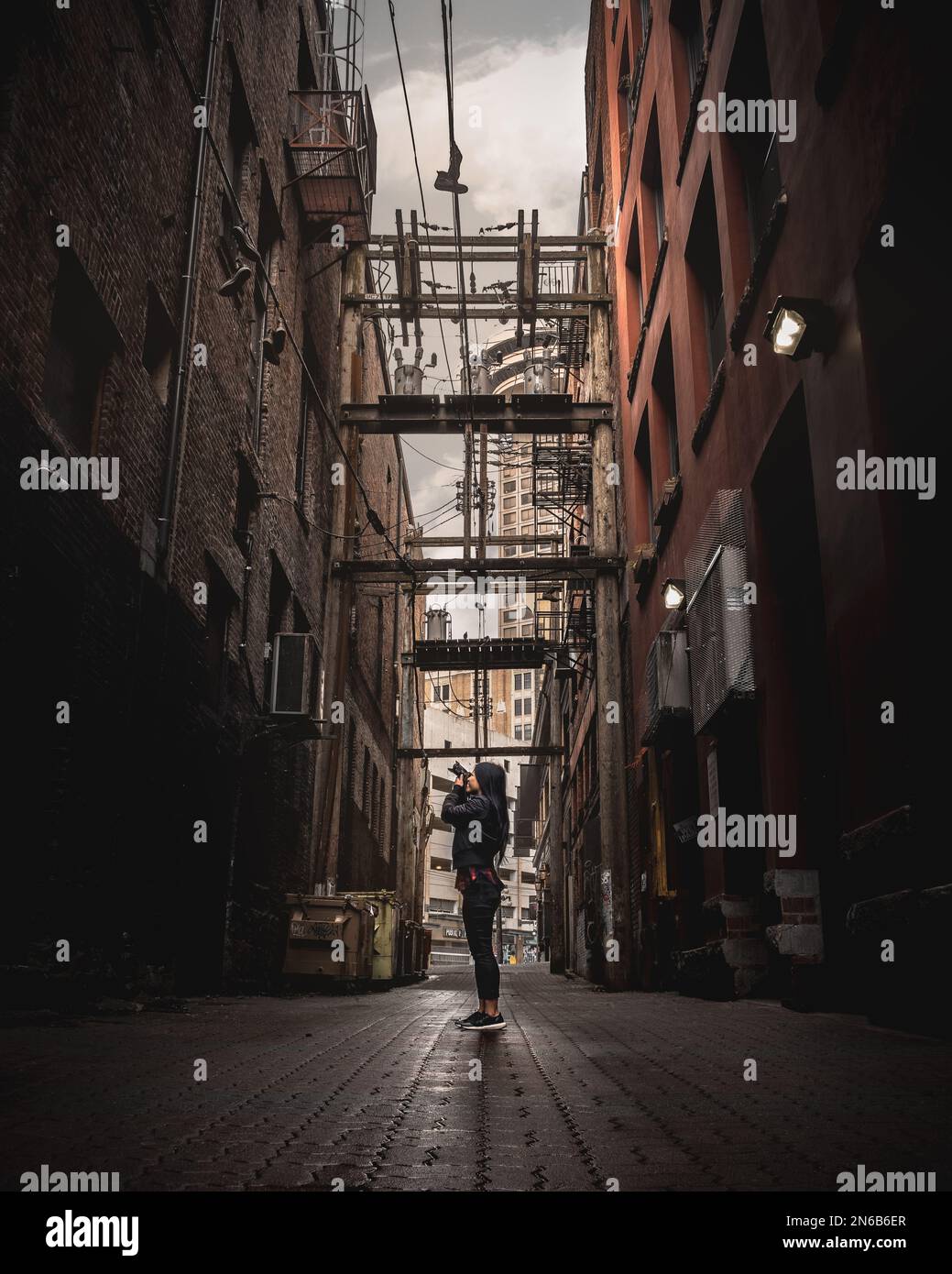 girl taking photo in alley Stock Photo - Alamy