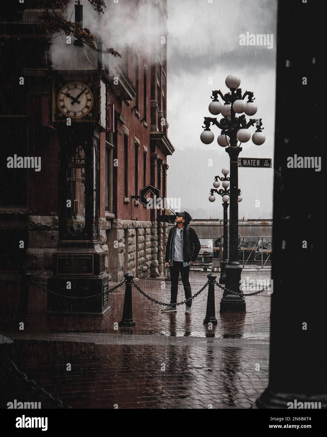 man looking at steam clock Stock Photo - Alamy