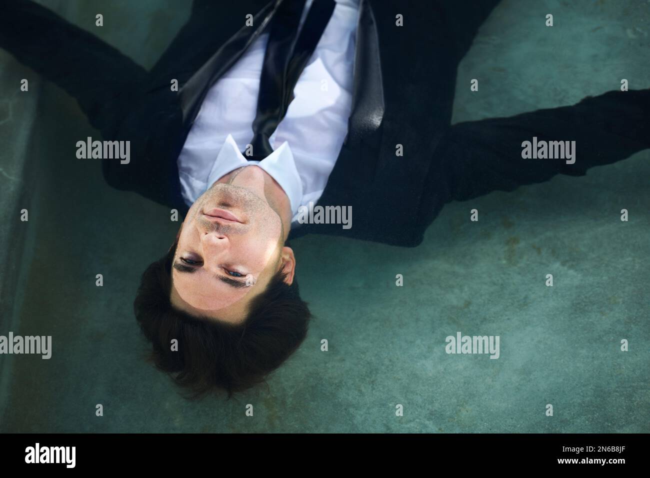 Keeping his head above water. Portrait of a young businessman wearing a ...