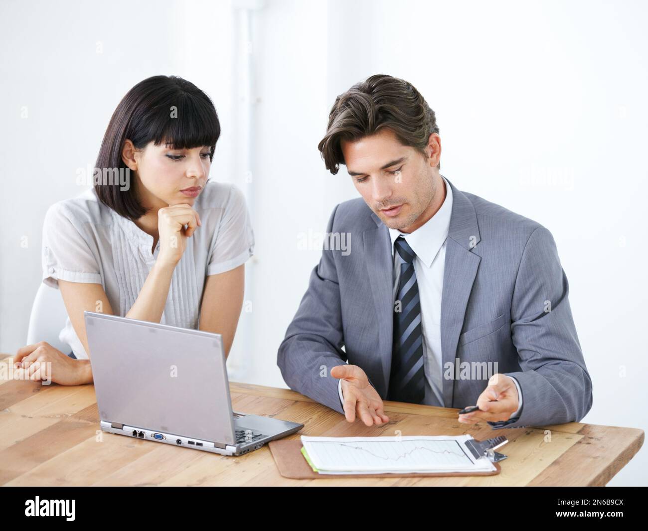 Going over important stats together. Two young executives having a ...