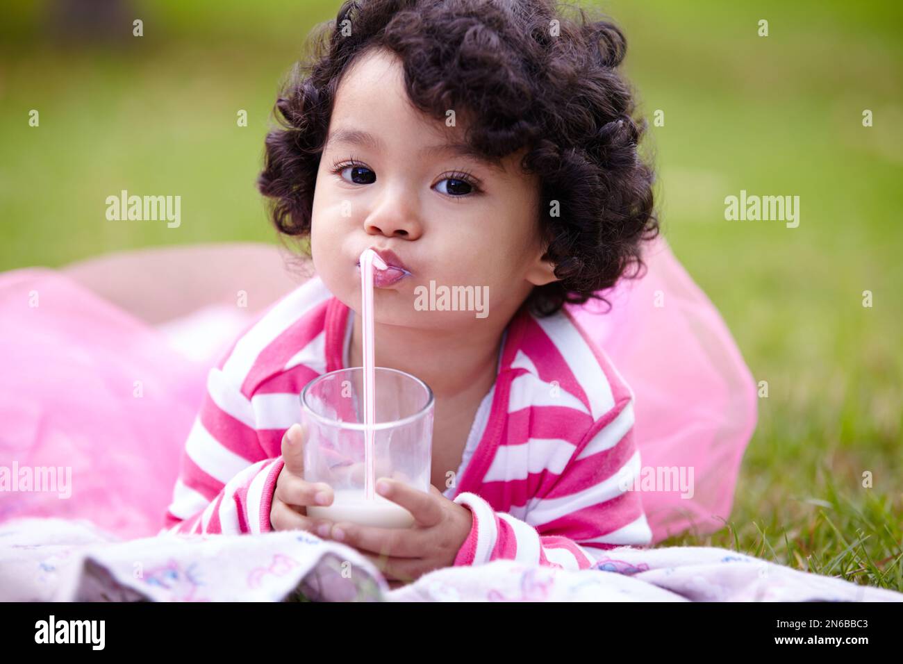 This milk tastes like more. an adorable little girl drinking a glass of ...