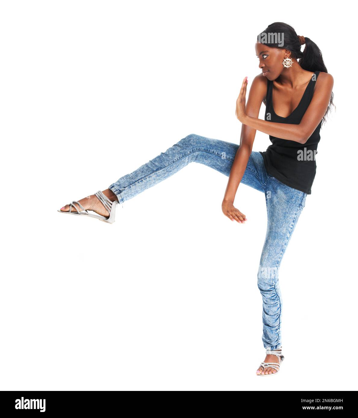 Ive got the right moves. Young woman posing in a martial arts position ...