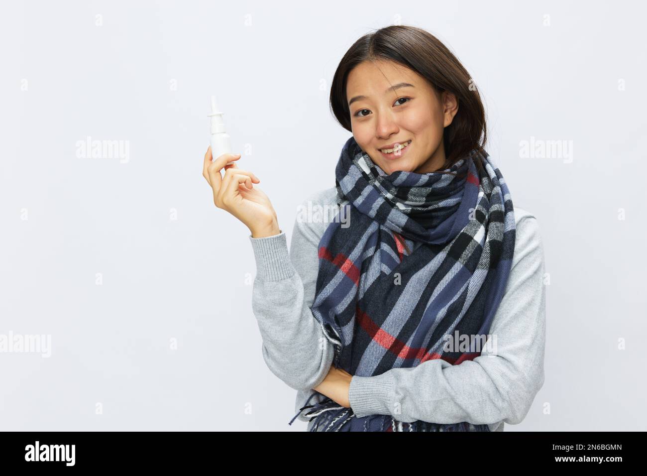 Happy Asian woman sickness spray nasal spray for allergies and colds ...