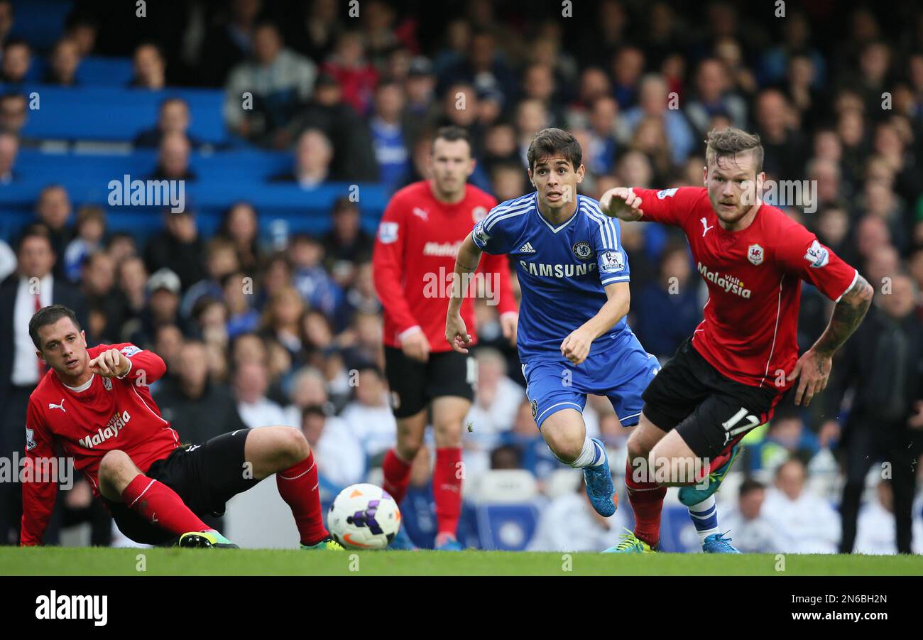 Chelsea's Oscar, centre, takes the ball past Cardiff's Aron Gunnarsson ...