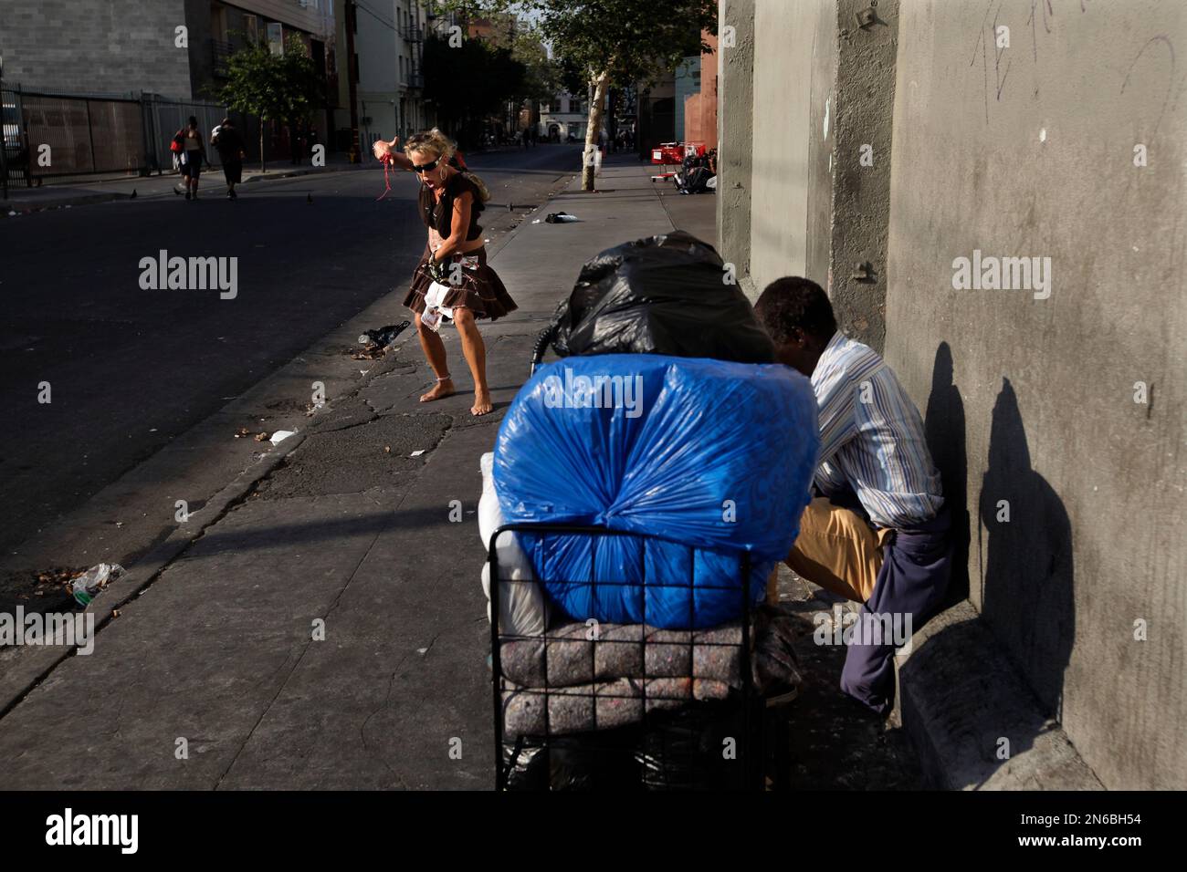 A barefoot homeless woman sings and dances in the Skid Row area of Los ...