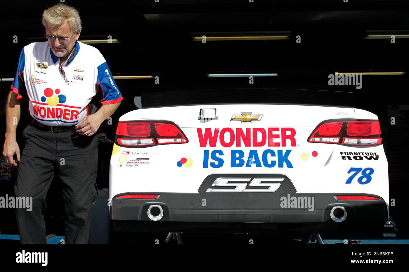 Pit crew member Jim Gilbert, of Denver, walks out of the Grand National ...
