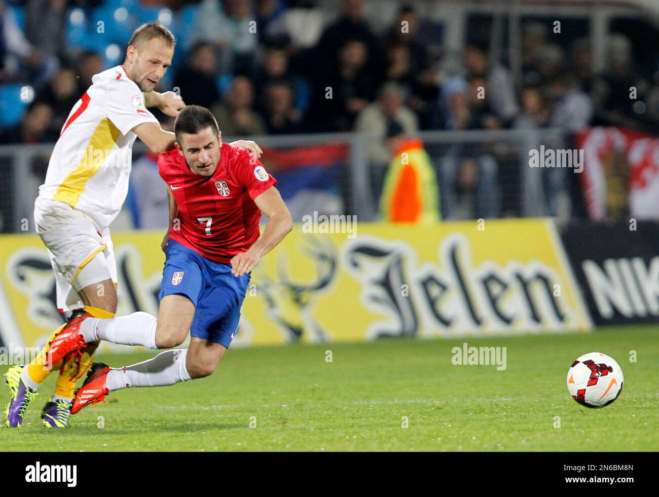 Serbia's Zoran Tosic, right challenges for the ball with Macedonia's ...