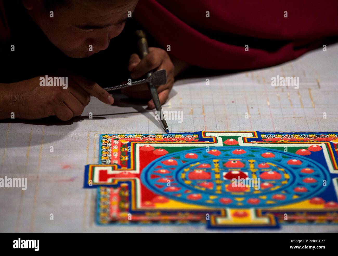 In this Oct. 16, 2013 photo, a Tibetan monk uses metal tools, also ...