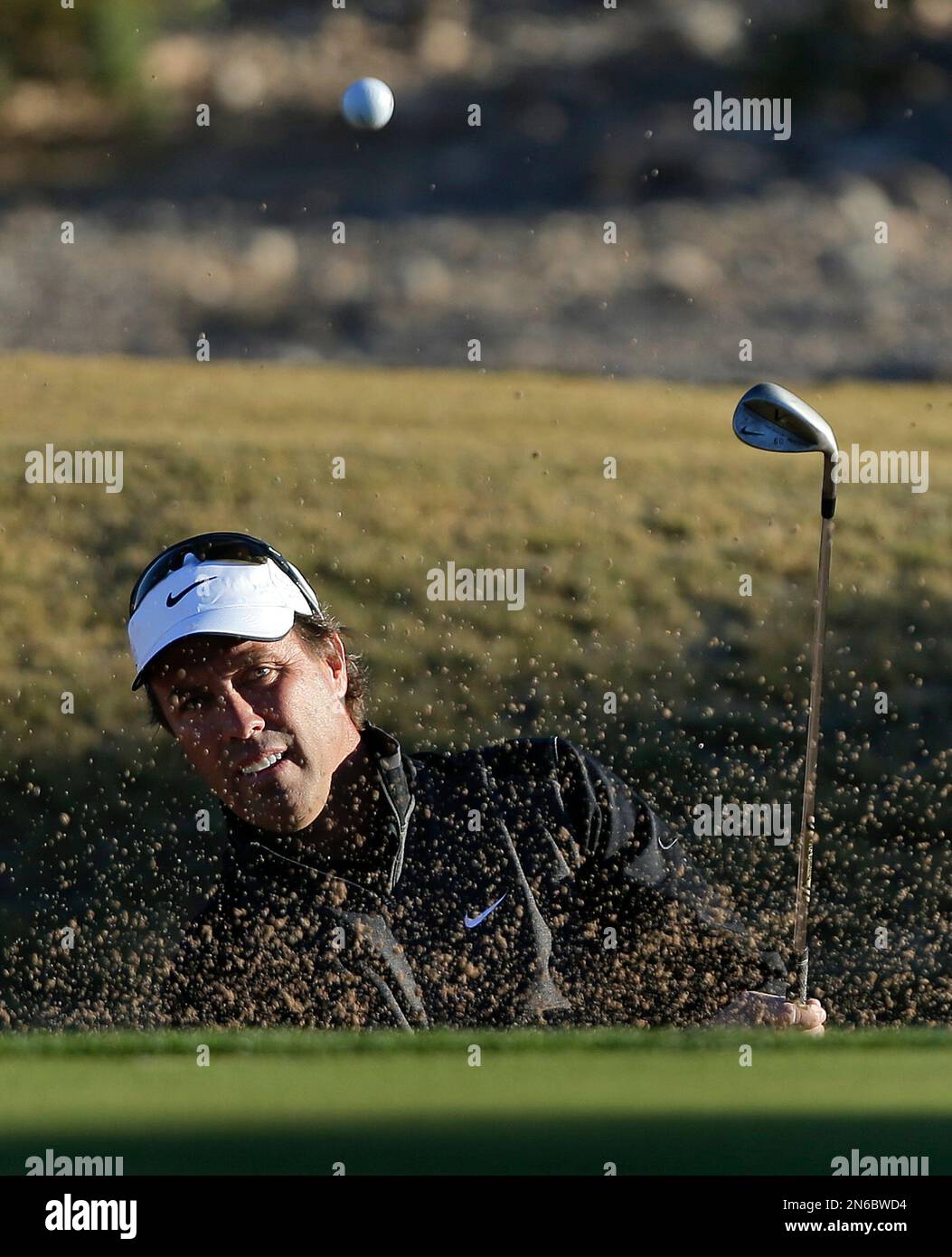 Stephen Ames, of Canada, hits out of a bunker onto the 14th green in ...