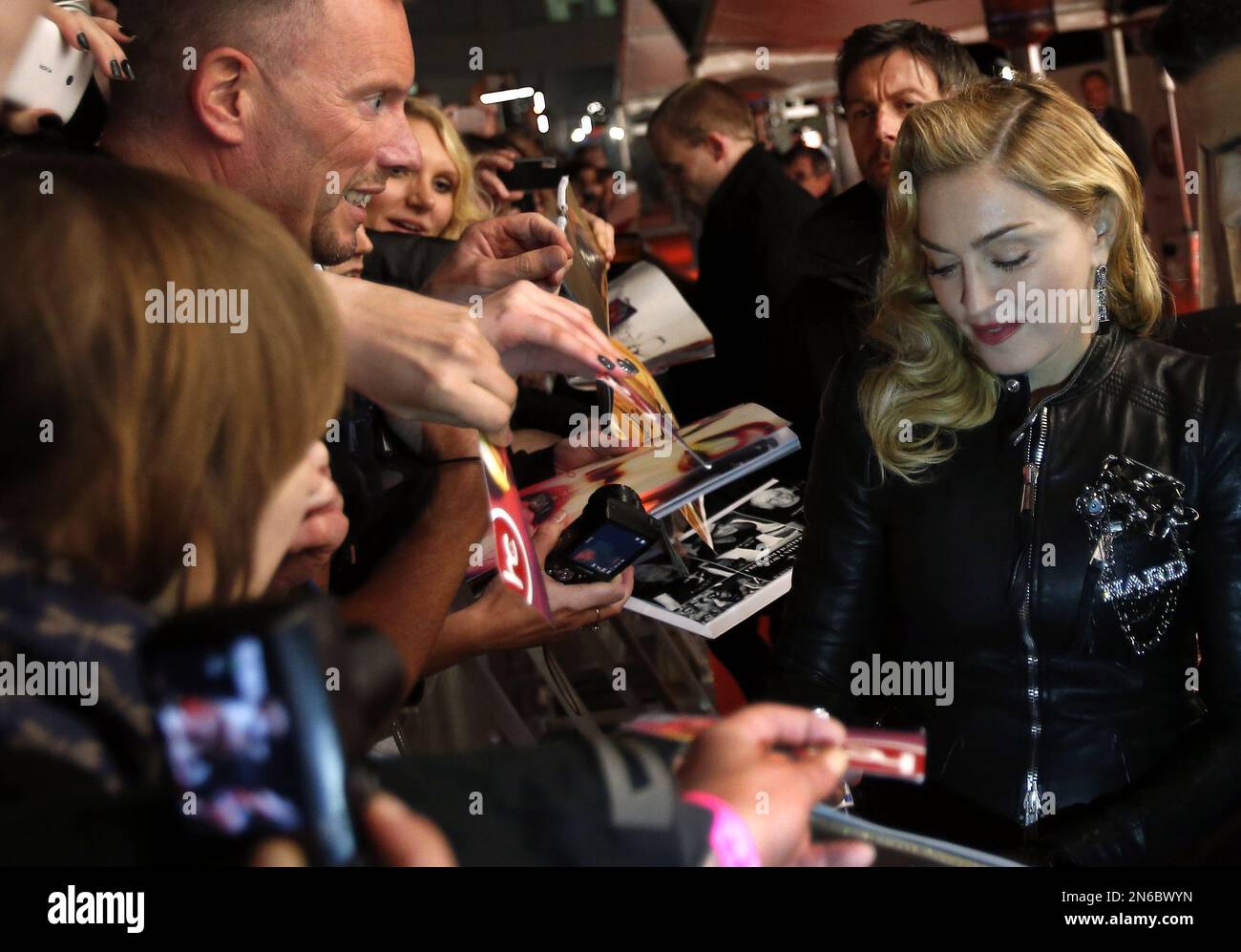 U.S. performer Madonna signs autographs as she arrives to visit the ...