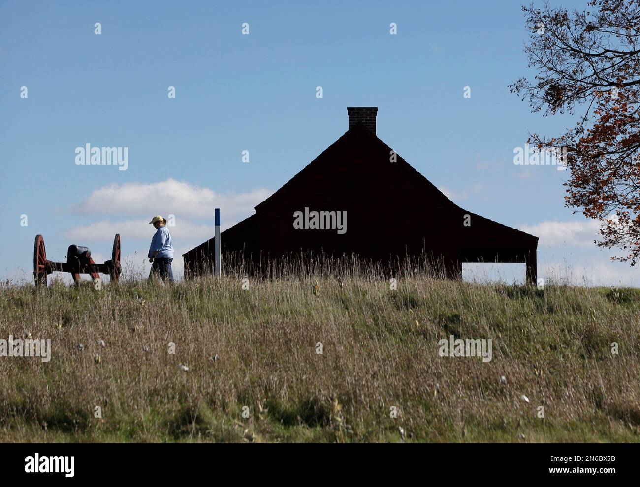Sally Larmon of Schuylerville, N.Y., walks near a cannon at the Neilson ...