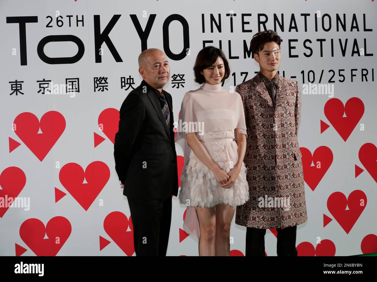 Japanese actors, Masami Nagasawa, center, and Masaki Okada, right ...
