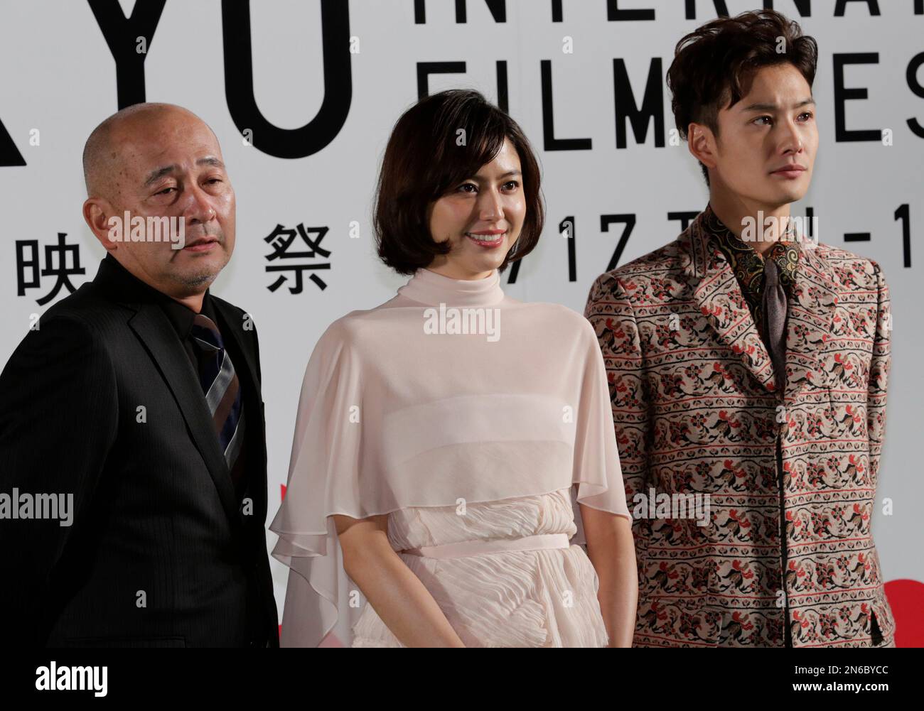 Japanese actors, Masami Nagasawa, center, and Masaki Okada, right ...