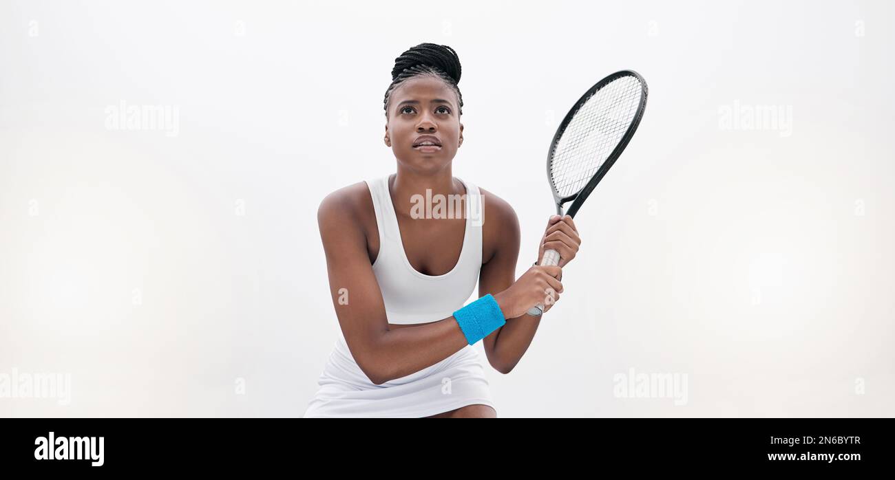 Focused tennis player ready for a match. Young woman waiting to play a ...