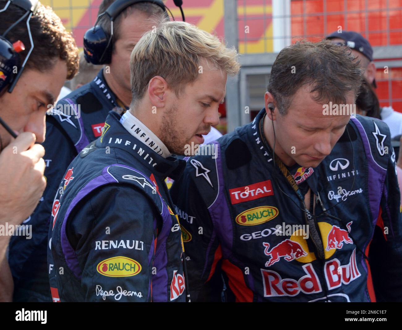 Red Bull driver Sebastian Vettel of Germany speaks with his mechanics ...