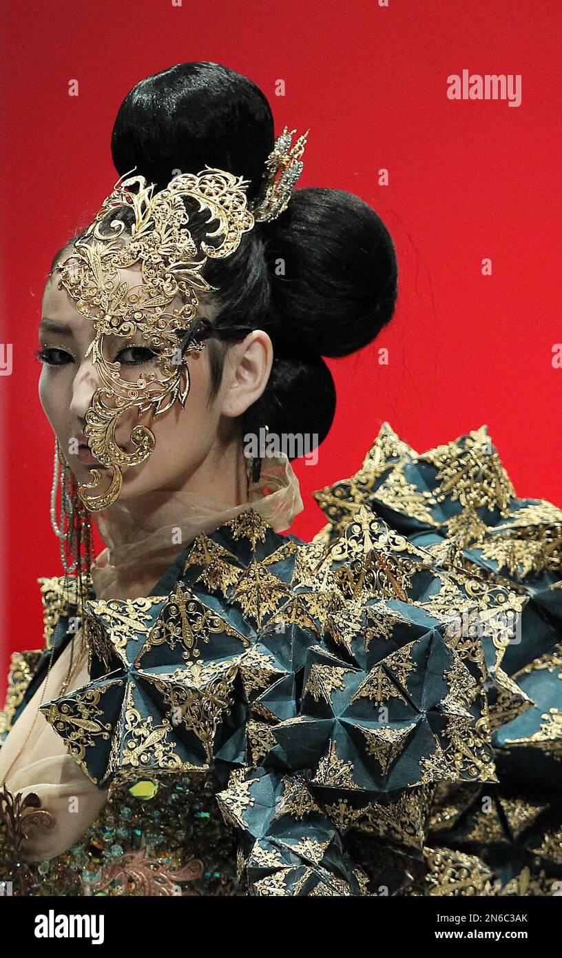 A model showcases an outfit by Chinese fashion design Guo Pei ...