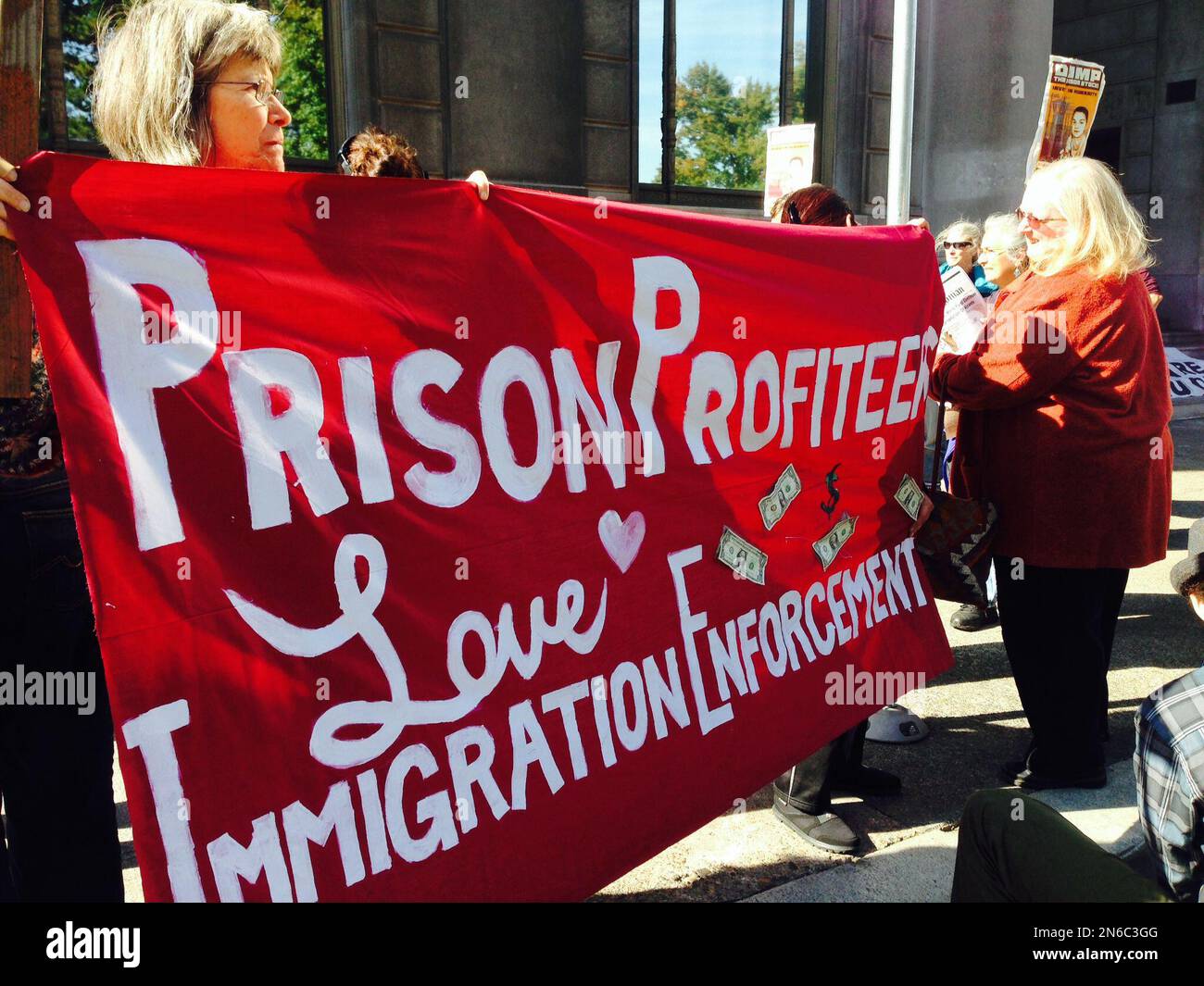 Immigration activists hold a banner while protesting in Portland, Ore ...