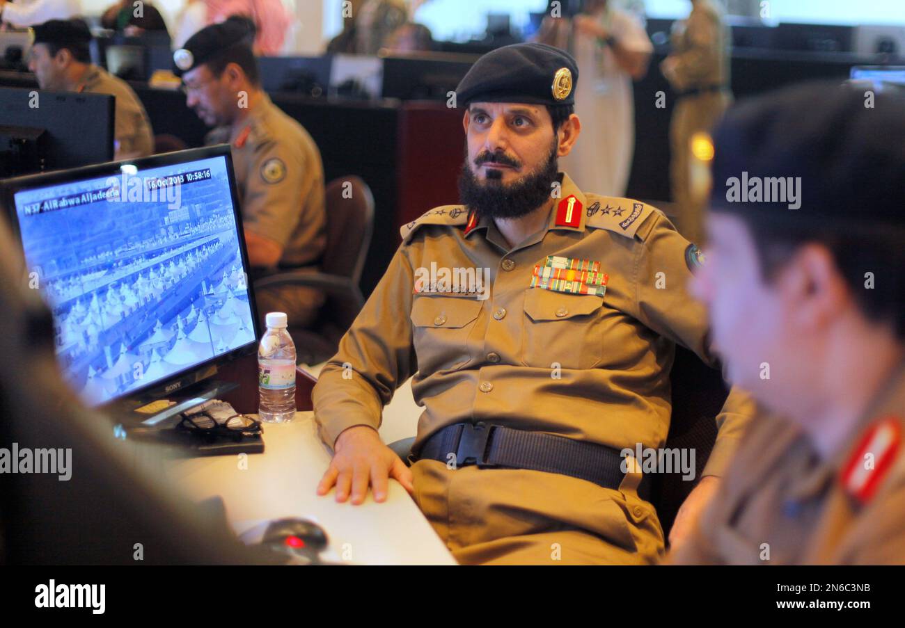 Saudi police officer Saud Bin Saad monitors screens connected to ...