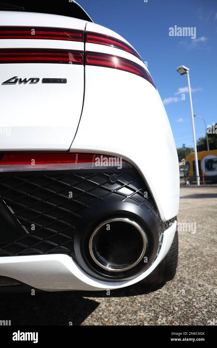 A back view of Genesis gv70 white car turbo Stock Photo - Alamy
