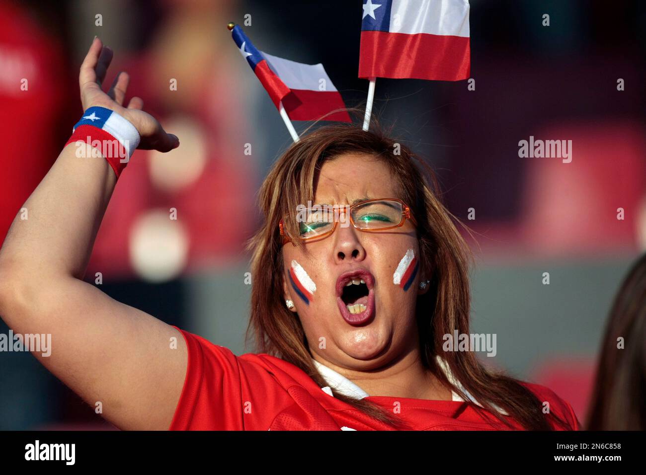 A Chile soccer fan gets revved up before the start of a 2014 World Cup ...