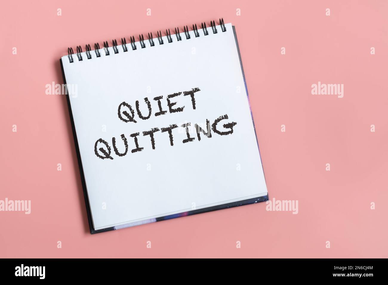 Quiet quitting text on notebook, on pastel pink background. Work life ...