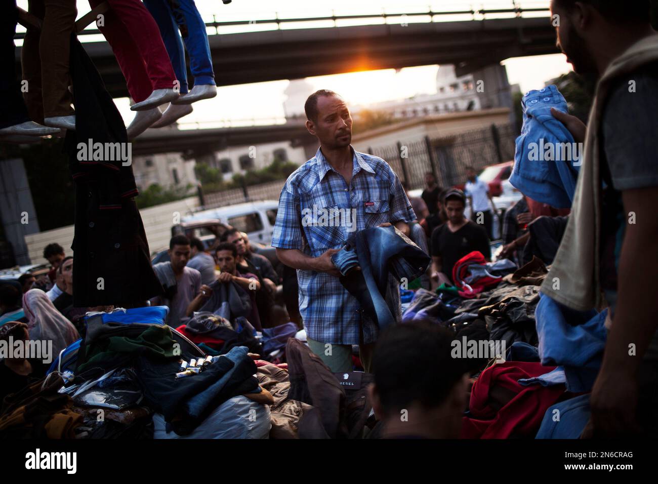 An Egyptian street vendor works at his stall in the Ataba market on the ...