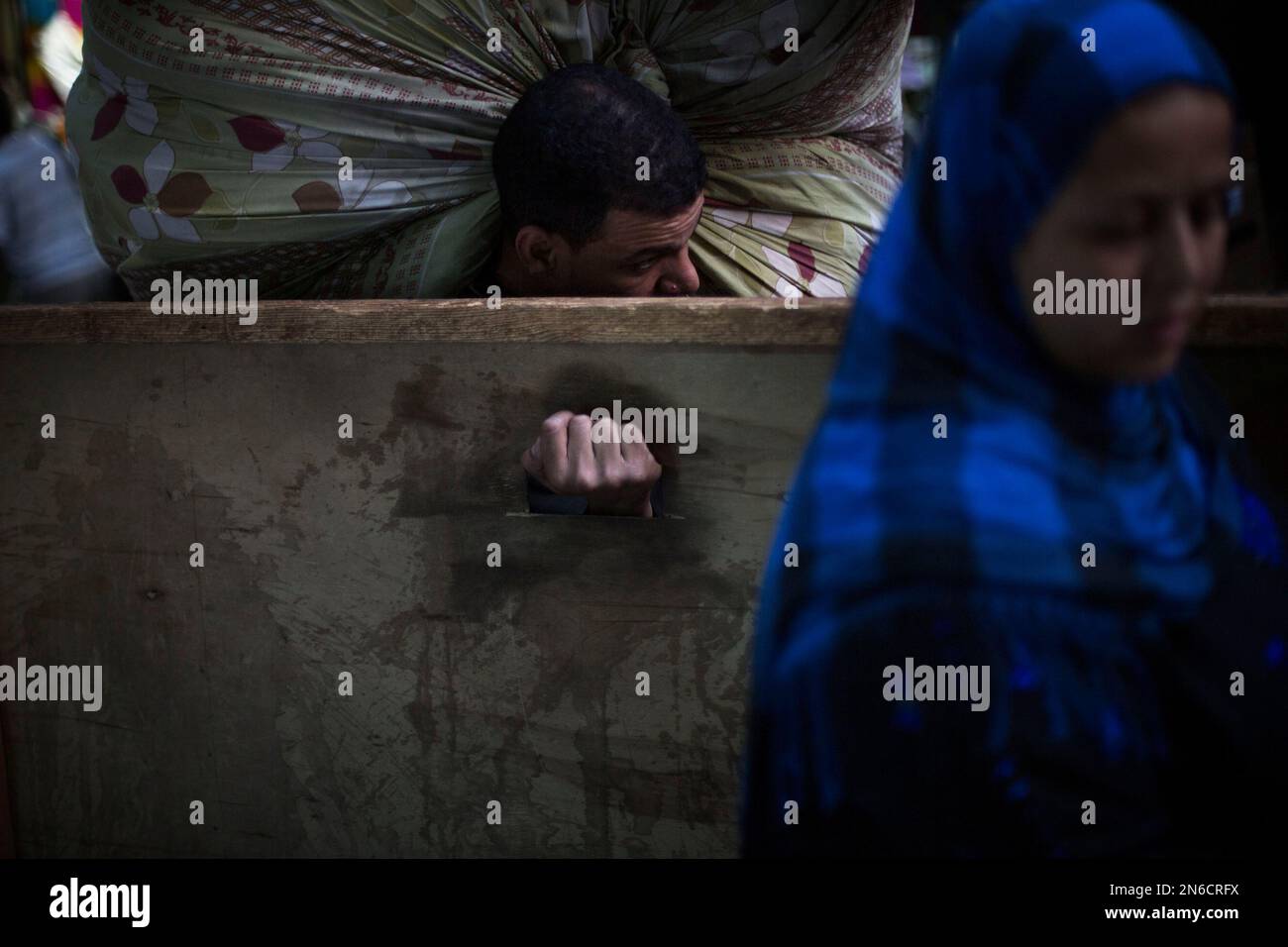 An Egyptian man carries his street stall in the Ataba market on the eve ...