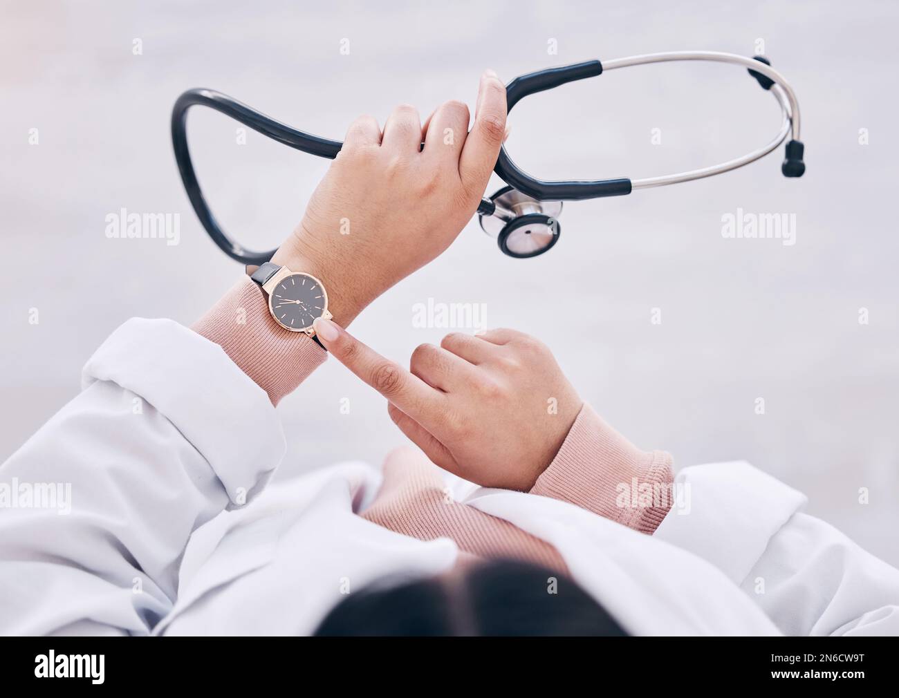 Top view, hands or doctor checking watch in hospital schedule, late ...